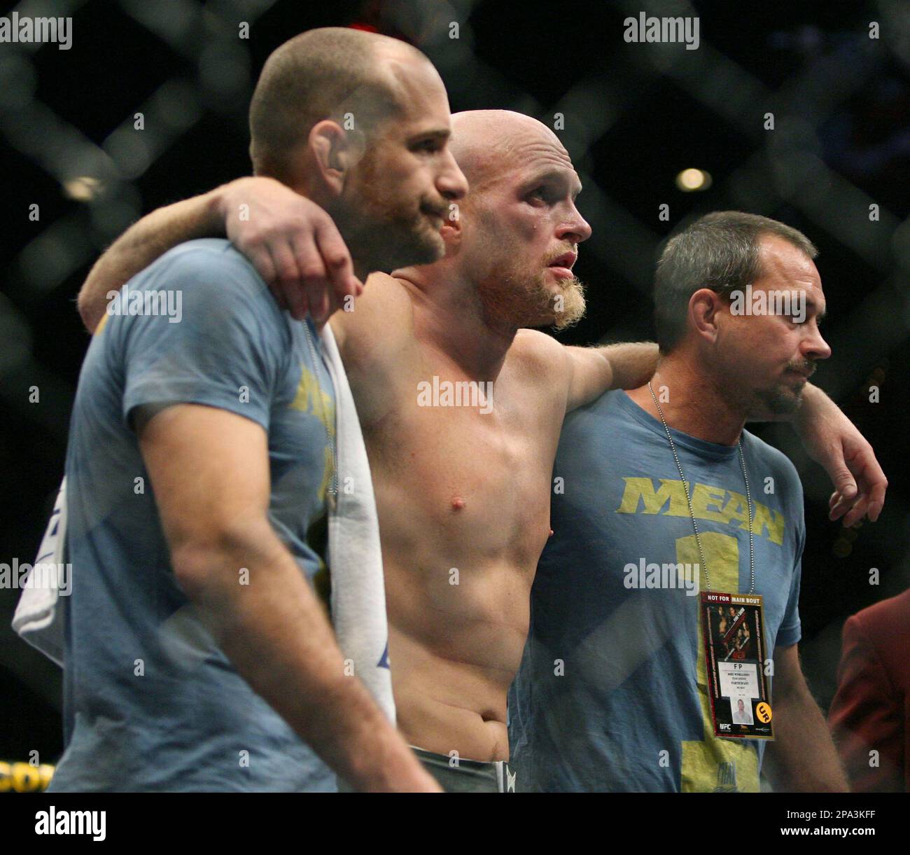 Keith Jardine, center, is assisted out of the ring by members of his corner after being knocked ...