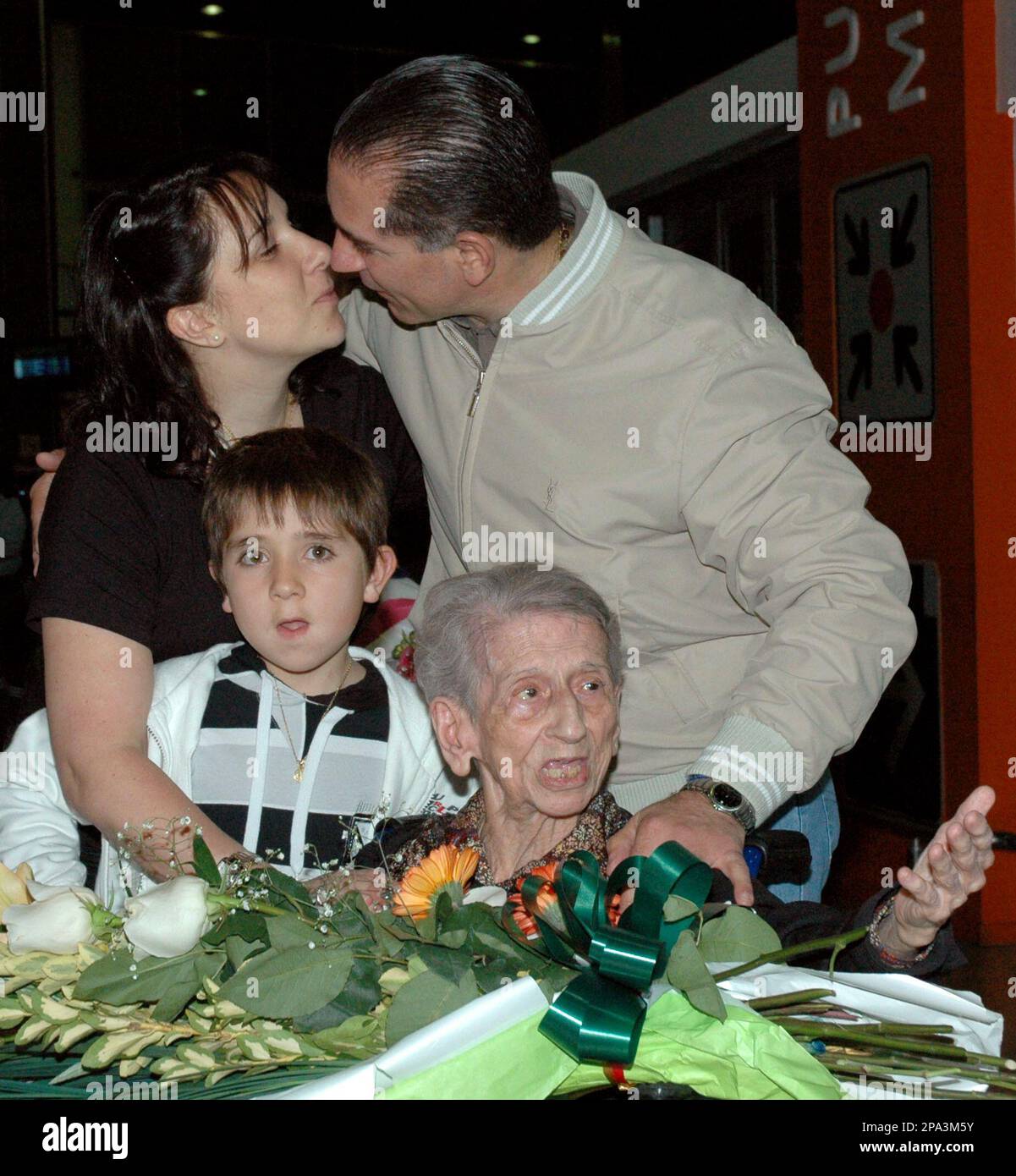 Cuban Hilda Morejon, bottom, is greeted by her grandson Roberto ...