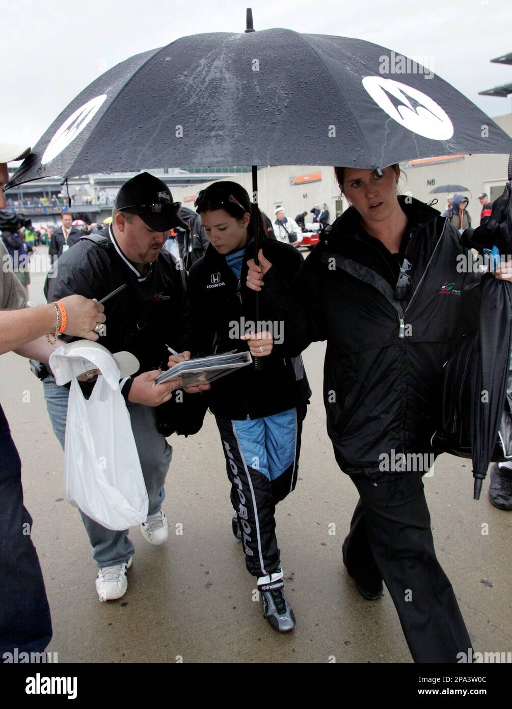 Danica Patrick signs an autograph after rain halted the final day of ...