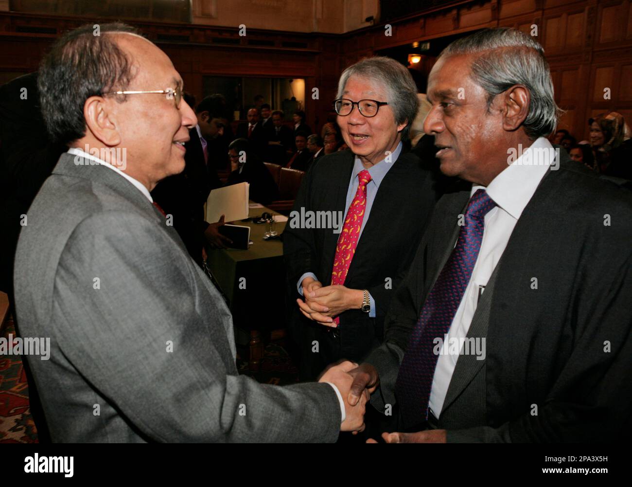 Malaysia's Foreign Minister Rais Yatim, left, shakes hands with ...