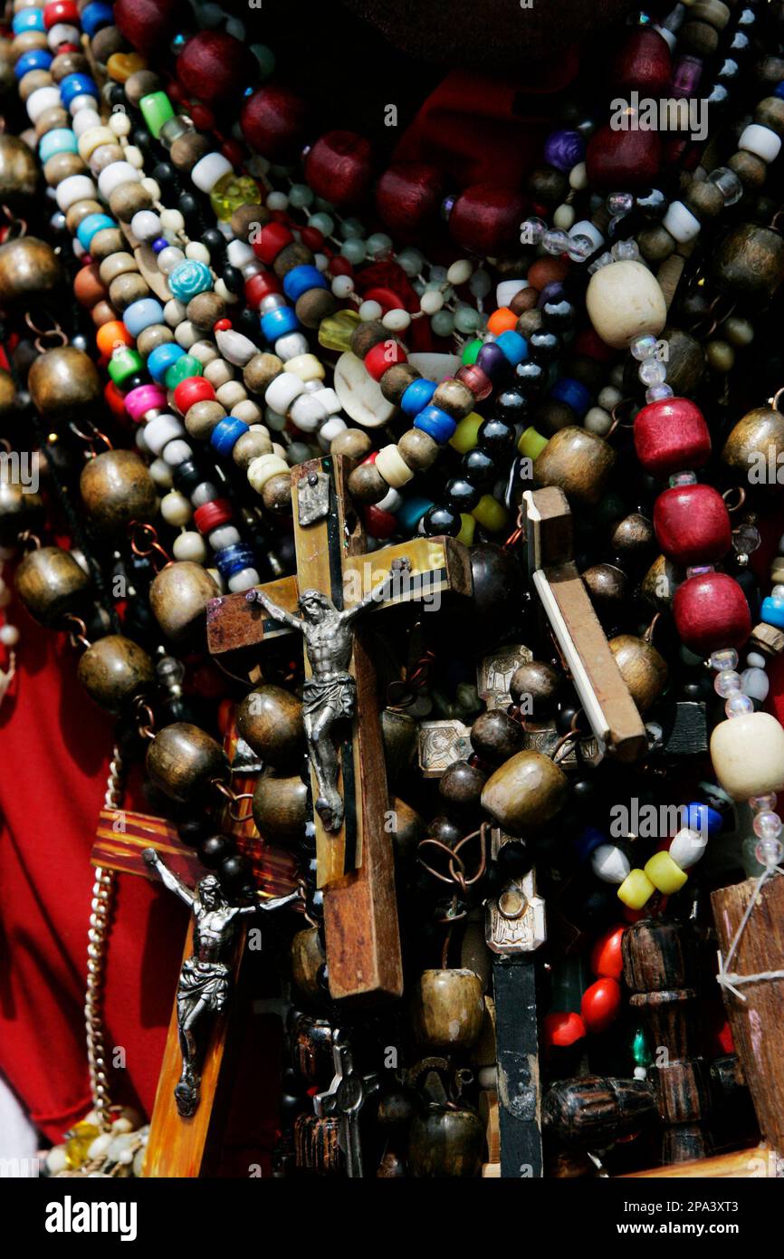 Crucifixes and beads hang from the neck of a dancing devil during ...