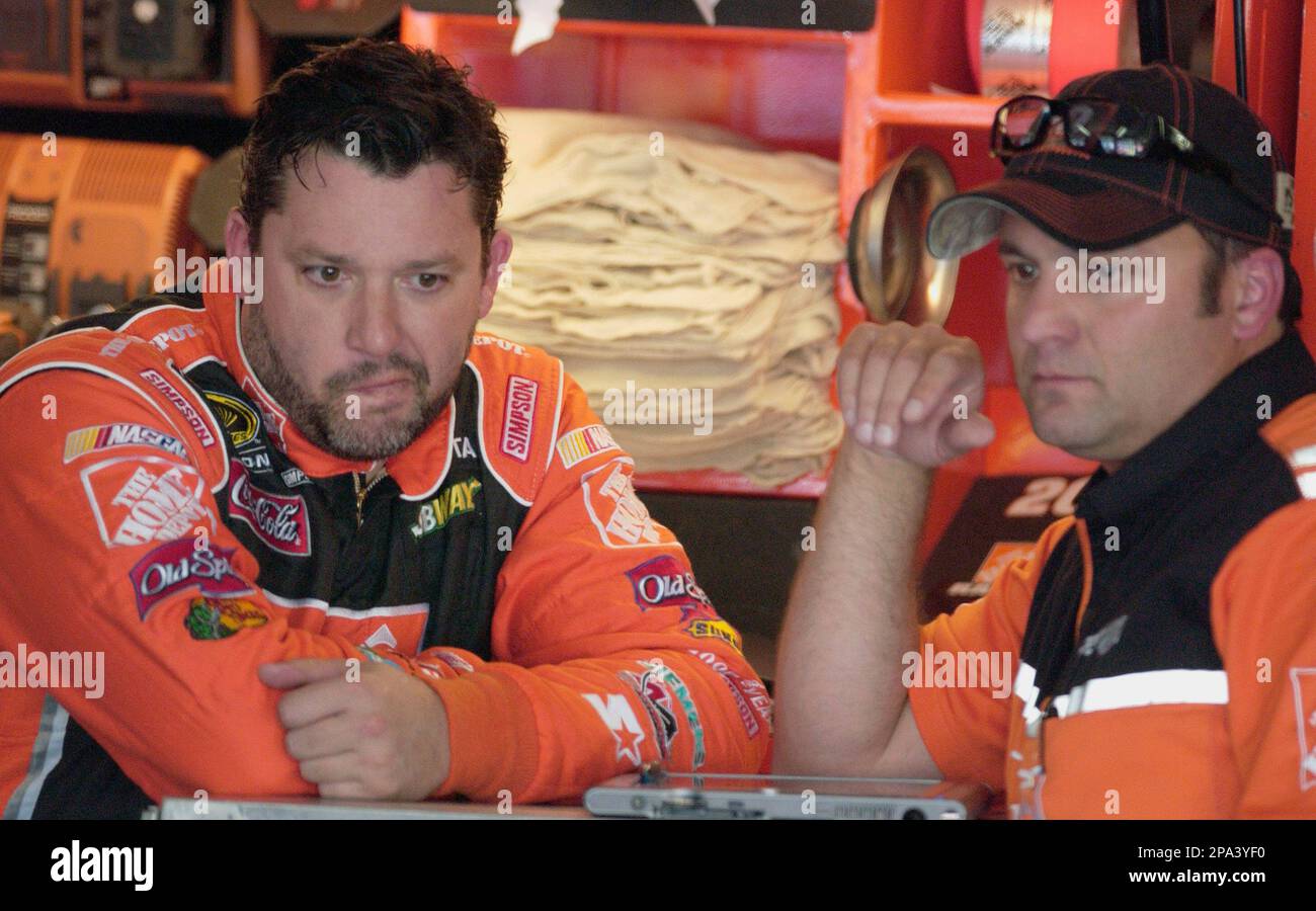 Tony Stewart, left, and crew chief Greg Zipadelli, right, talk in the ...