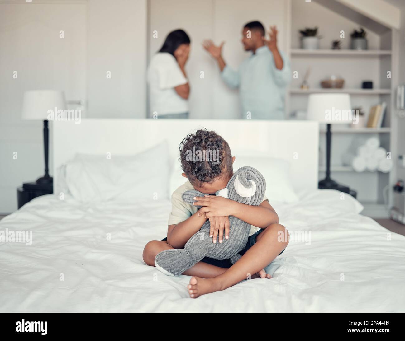Sad, fight and boy on the bed with parents in conflict depression, anxiety and stress in their ...