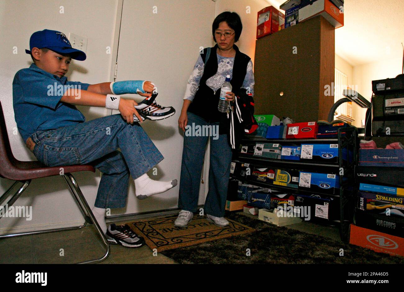 Moshe Kai Cavalin, 10, gets ready for school at home with his mother ...