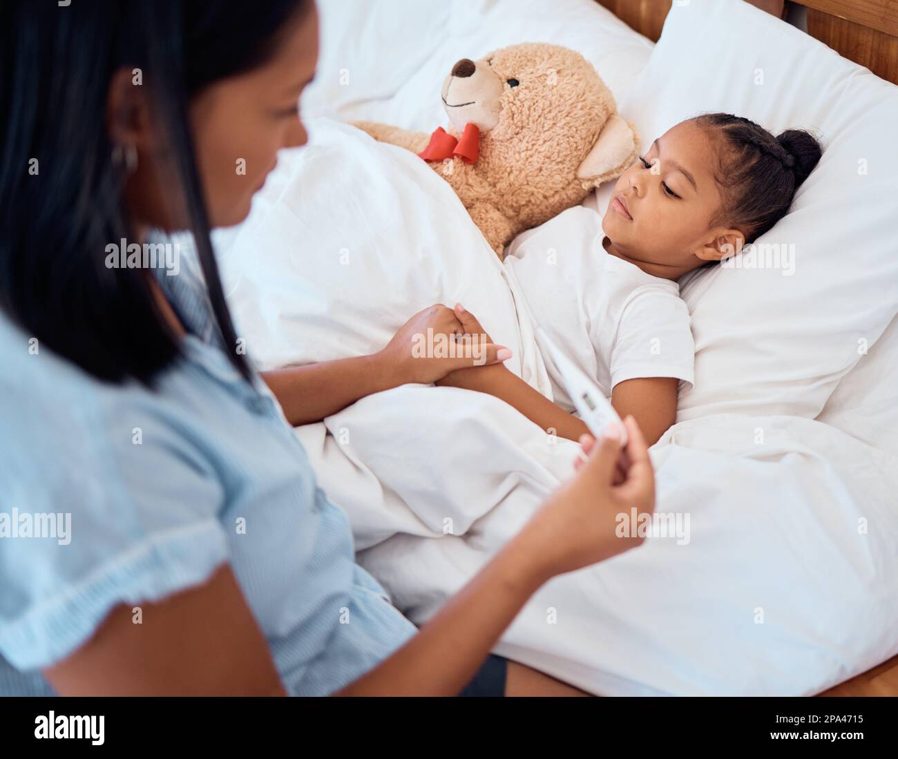 Sick, thermometer and mother helping child in bed healthcare, virus check and monitor progress ...