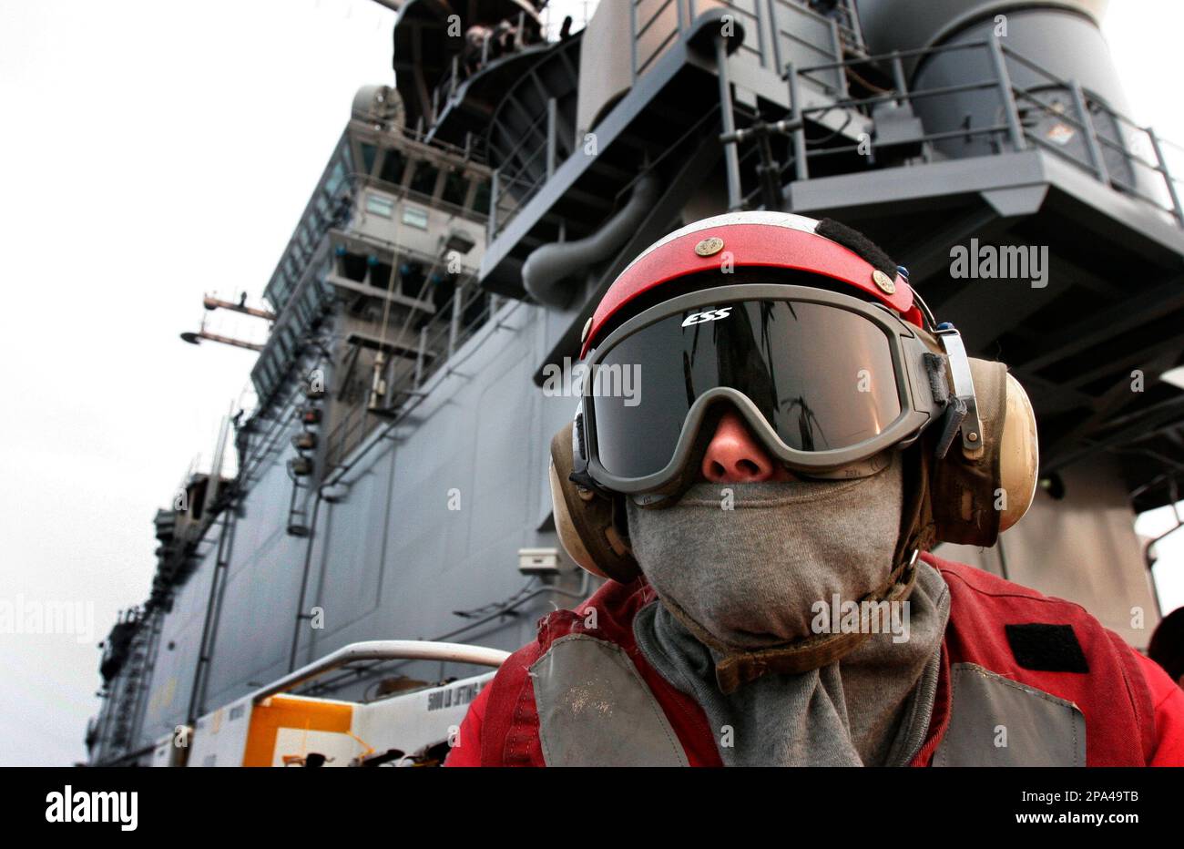 A crew member is seen on the flight deck of the light aircraft carrier ...