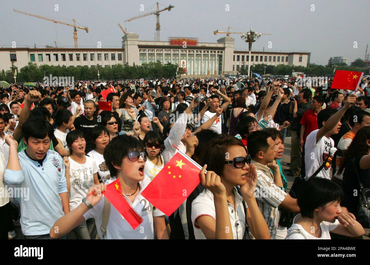 Chinese people shout "Long Live China!", waving Chinese national flags ...