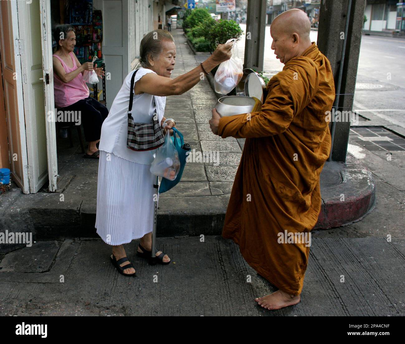 Buddhist monk accepts offerings from the faithful Monday, May 19, 2008 ...