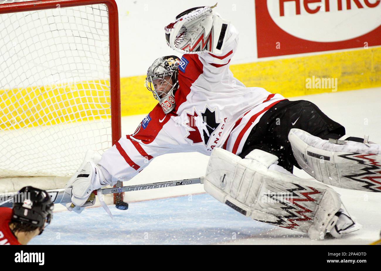 Team Canada goaltender Cam Ward dives to make a save over Team Russia ...