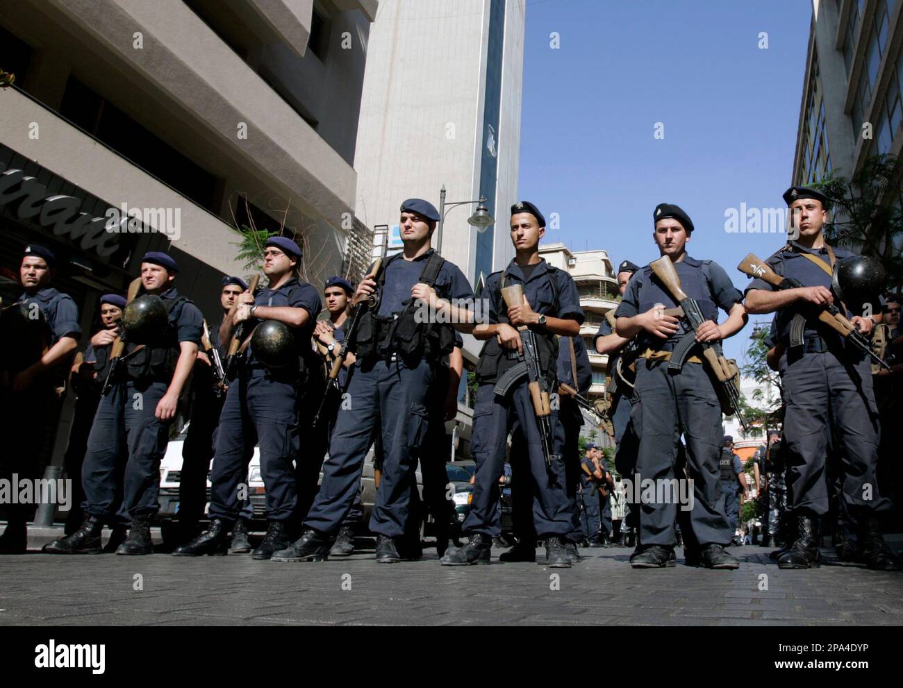 Lebanese riot police stand guard during a protest against recent ...