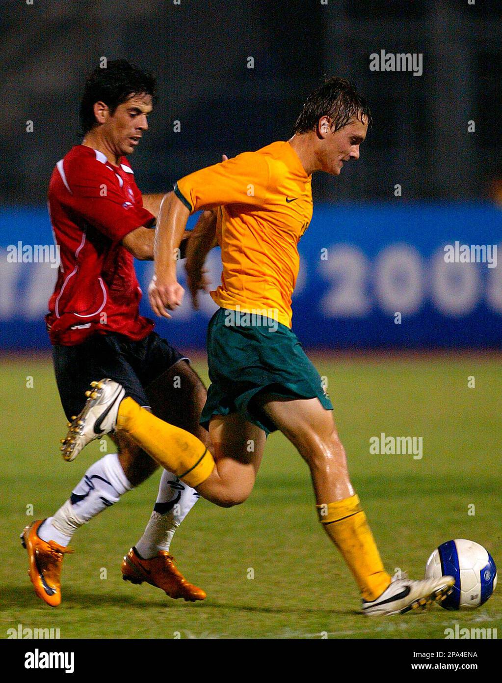 Australia's James Robert Holland, right, controls the ball as Chile's ...