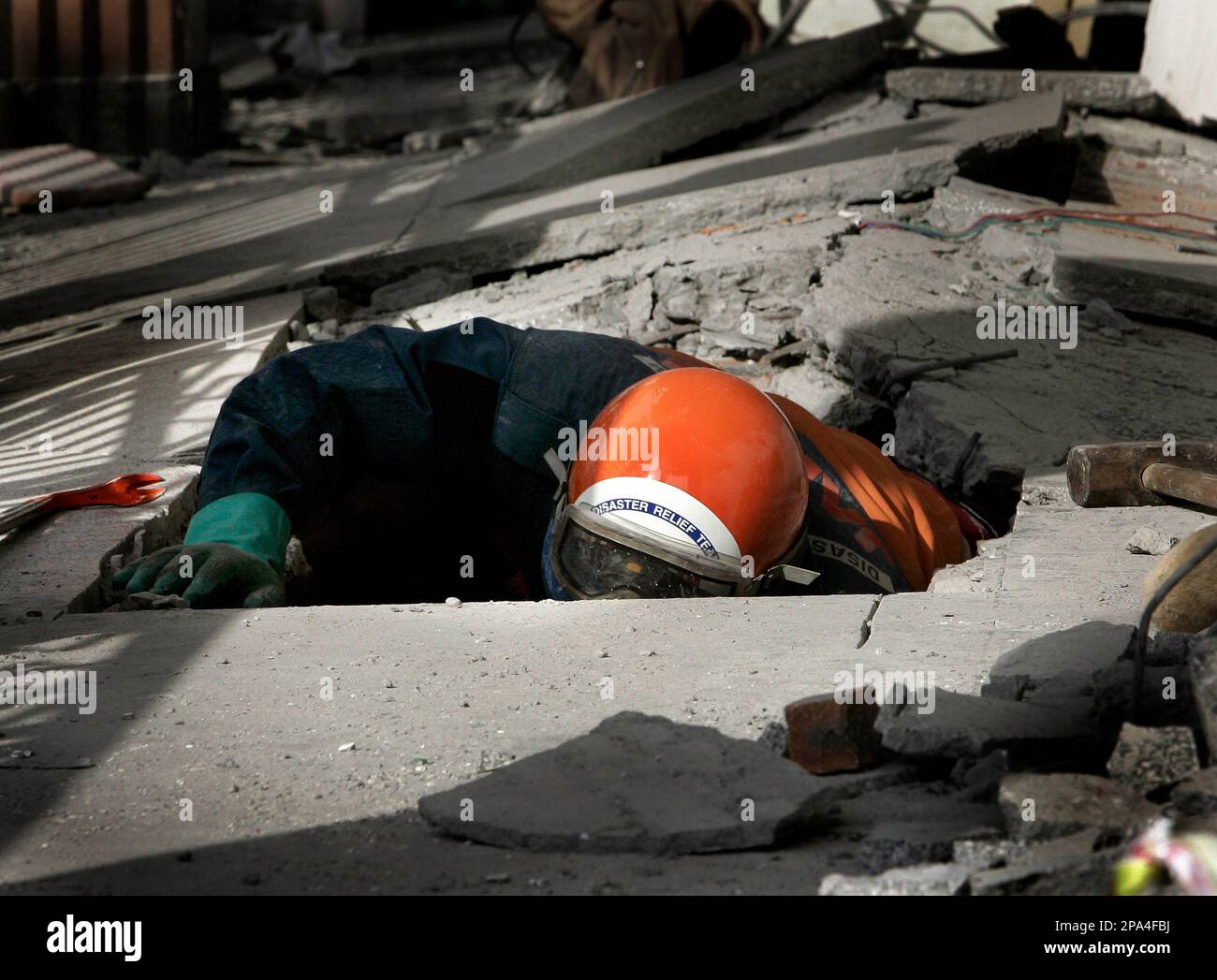 A Japanese disaster relief team member searches for earthquake ... A Japanese disaster relief team member searches for earthquake ...
