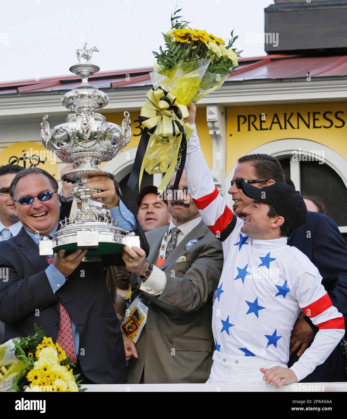 Trainer Richard Dutrow, left, hoists the trophy with Richard Schiavo, a ...