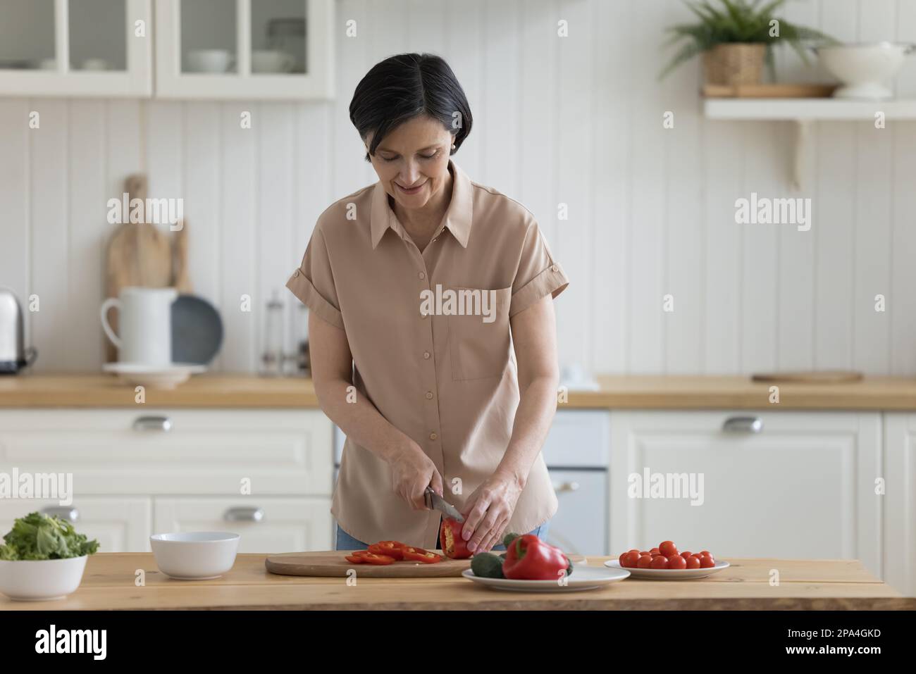 Attractive middle age woman cooking hi-res stock photography and images ...