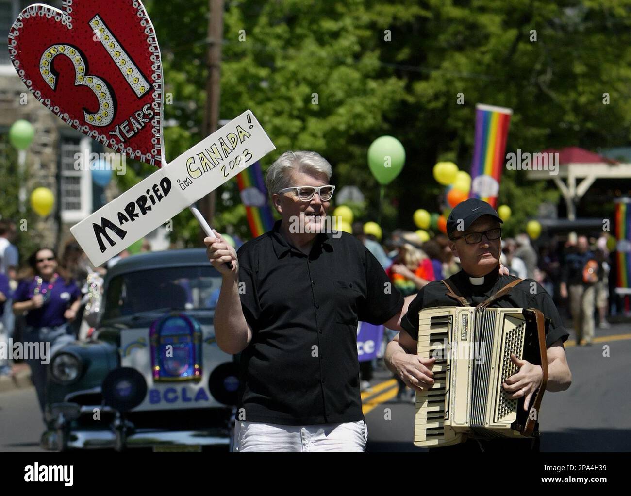 Tim Hare, left, and his partner Rev. Earl Ball walk in the gay pride ...