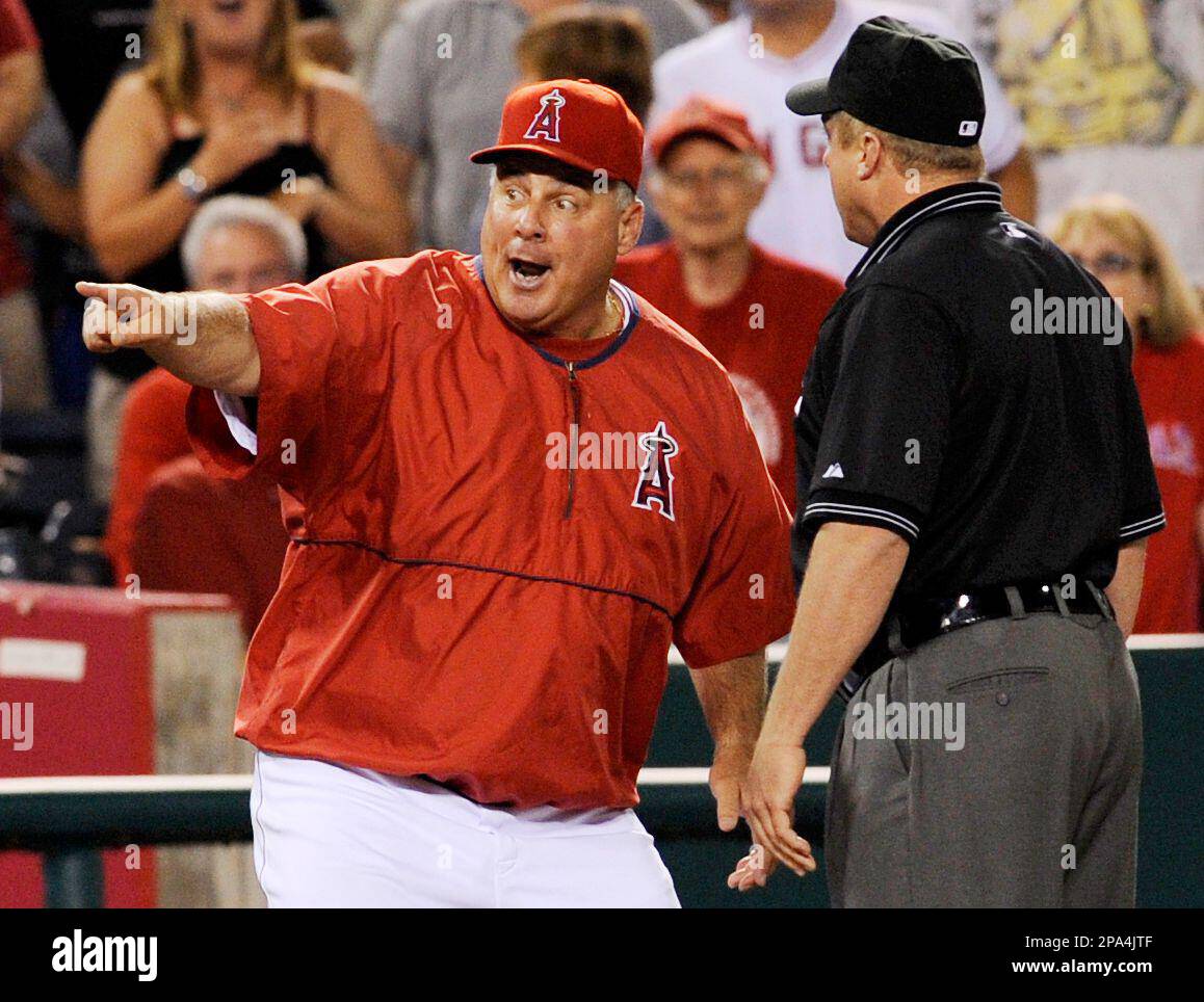 Los Angeles Angels manager Mike Scioscia, left, argues third base ...