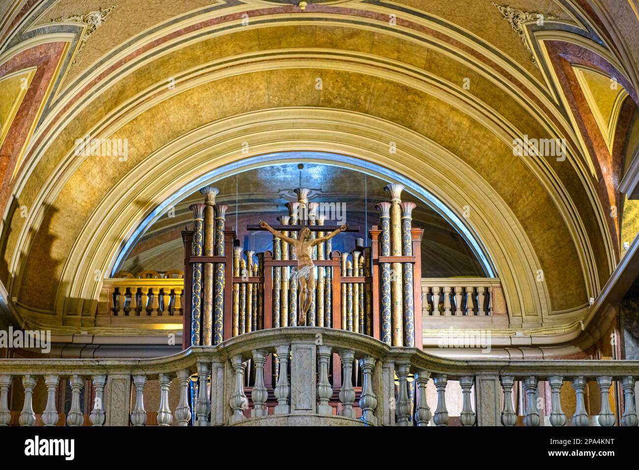 A sculpture or statue of the crucified Jesus Christ by the pipe organ ...