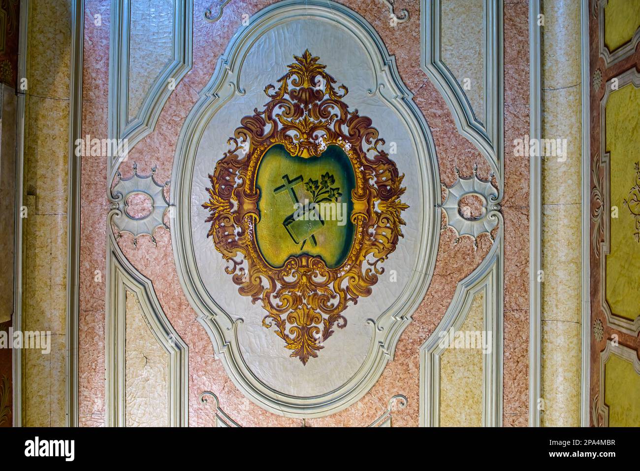 Christian symbols including a bible and a cross decorate the ceiling of ...