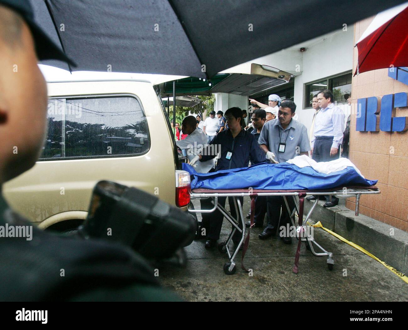 The body of one of nine victims is taken out of the RCBC Bank following ...
