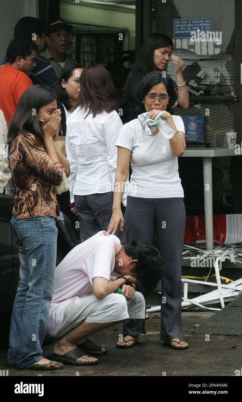 Relatives of nine victims killed in a bank robbery mourn outside the ...