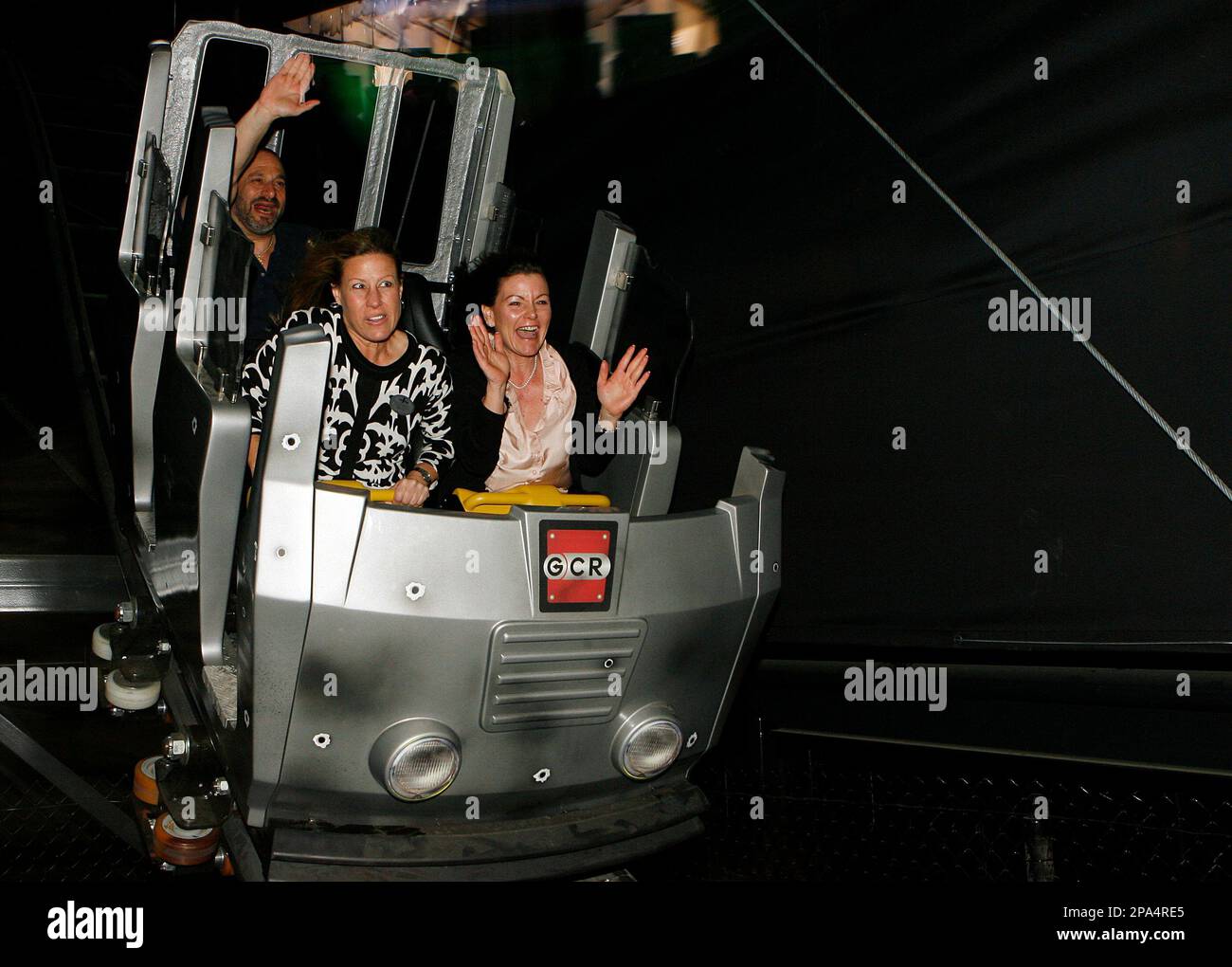 Visitors ride "The Dark Knight Coaster" attraction at Six Flags Great ...