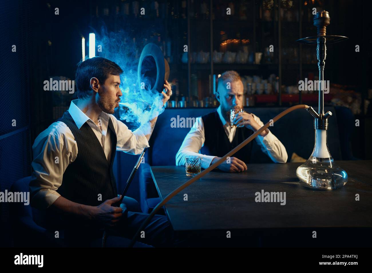 Stylish gangsters smoking hookah in bar having business meeting Stock ...