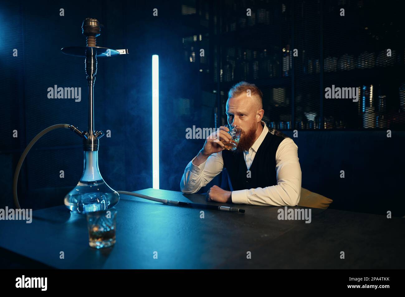 Stylish guy in suit drinking whisky at hookah bar Stock Photo - Alamy