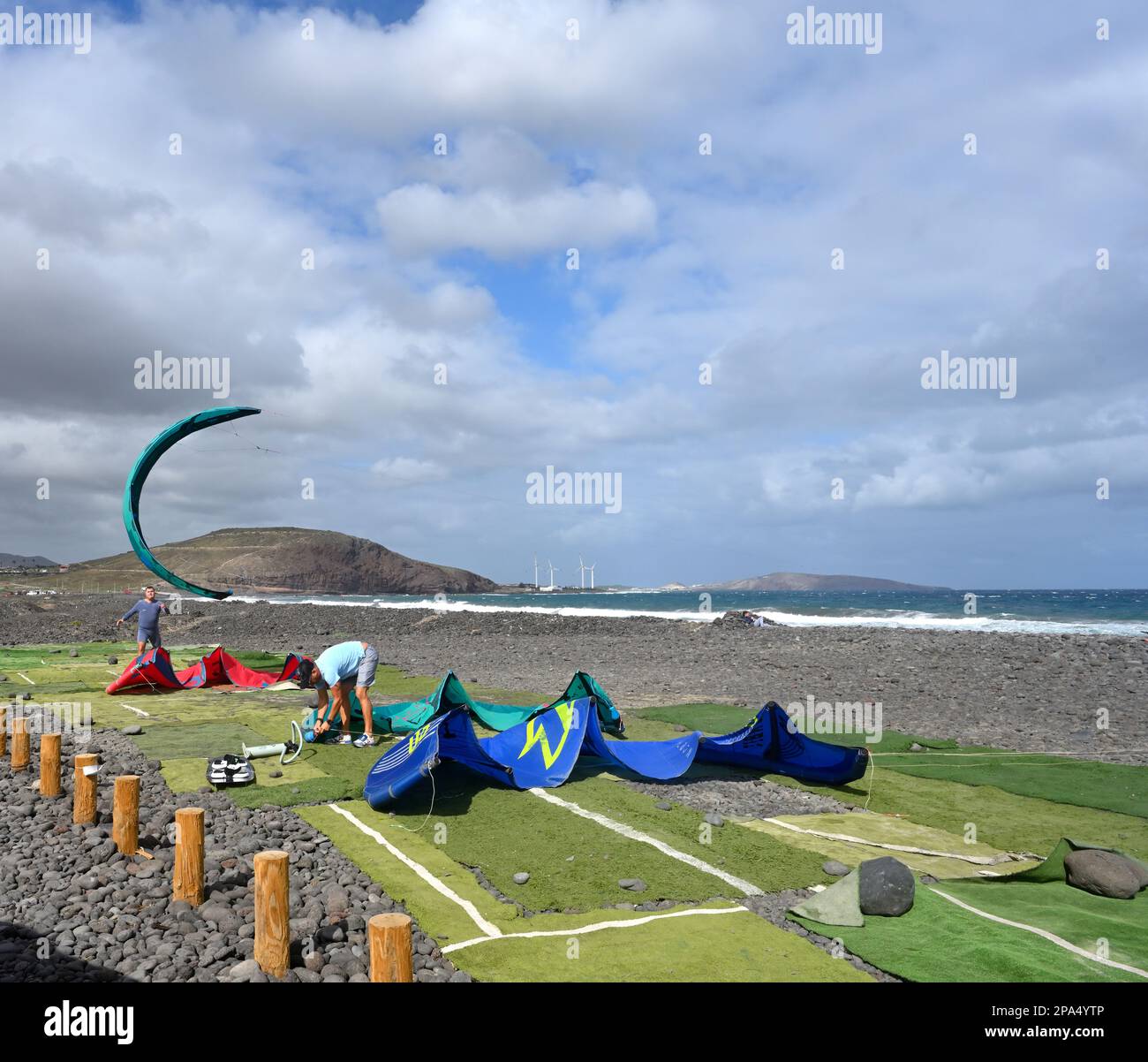 Kitesurfers pumping up the inflatable canopy of wings for kitesurfing ...