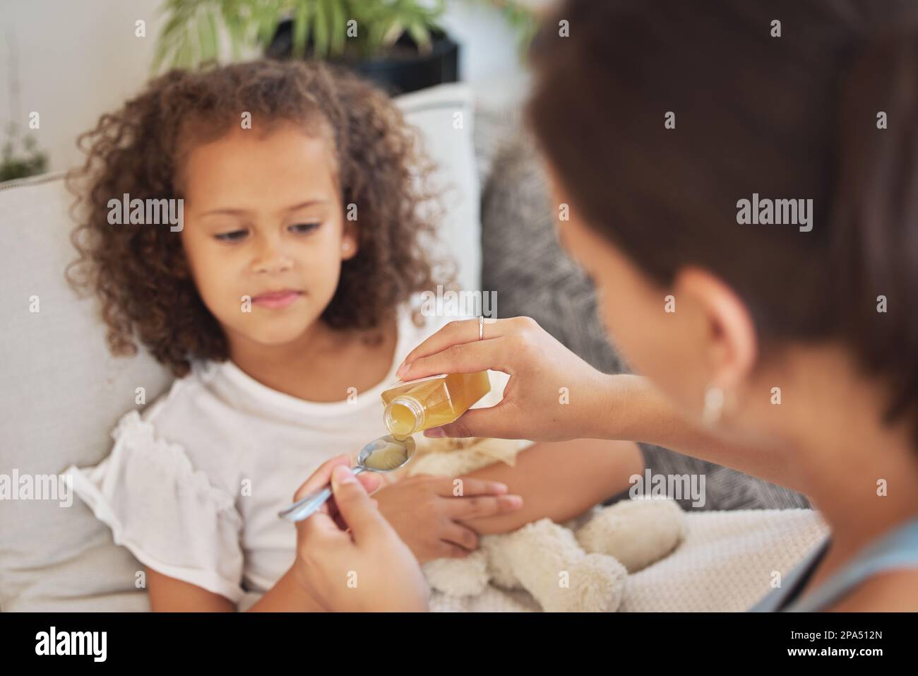 Sick daughter taking medicine as a treatment, cure or remedy while ...