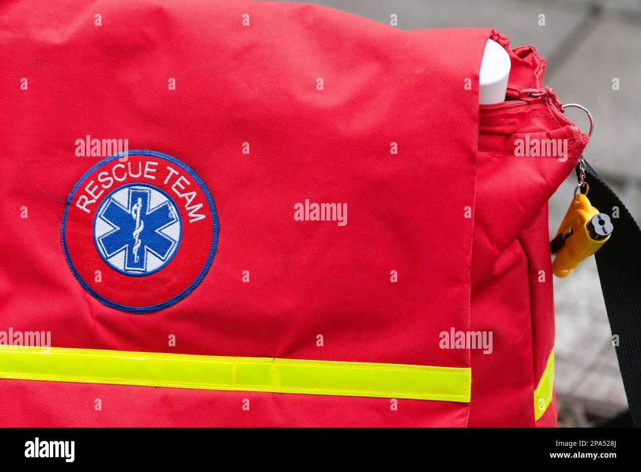 Detail shot of red medical rescue bag with yellow reflective strip in ...