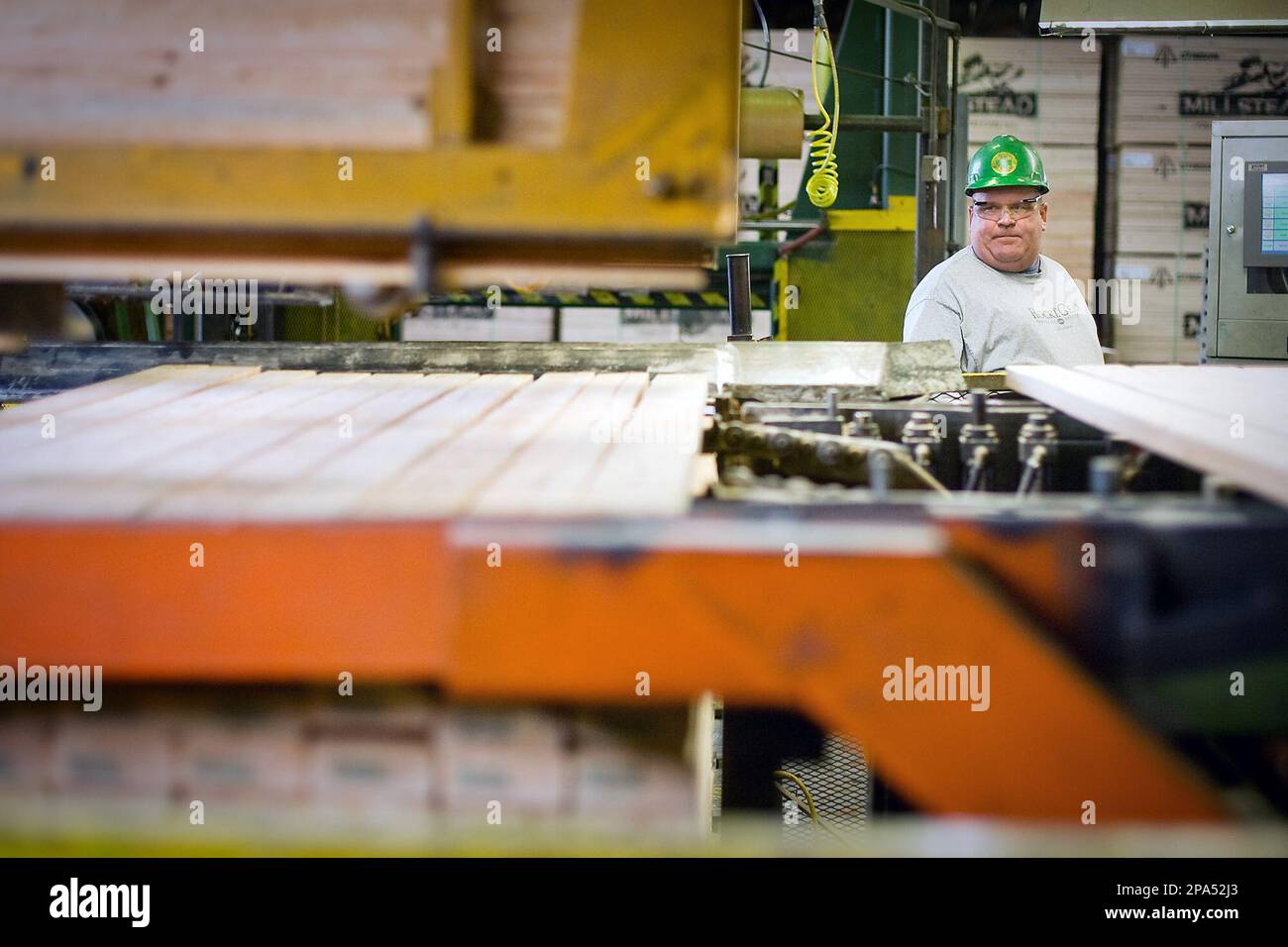 Dave Winters keeps an eye on the stacking machinery during his shift ...