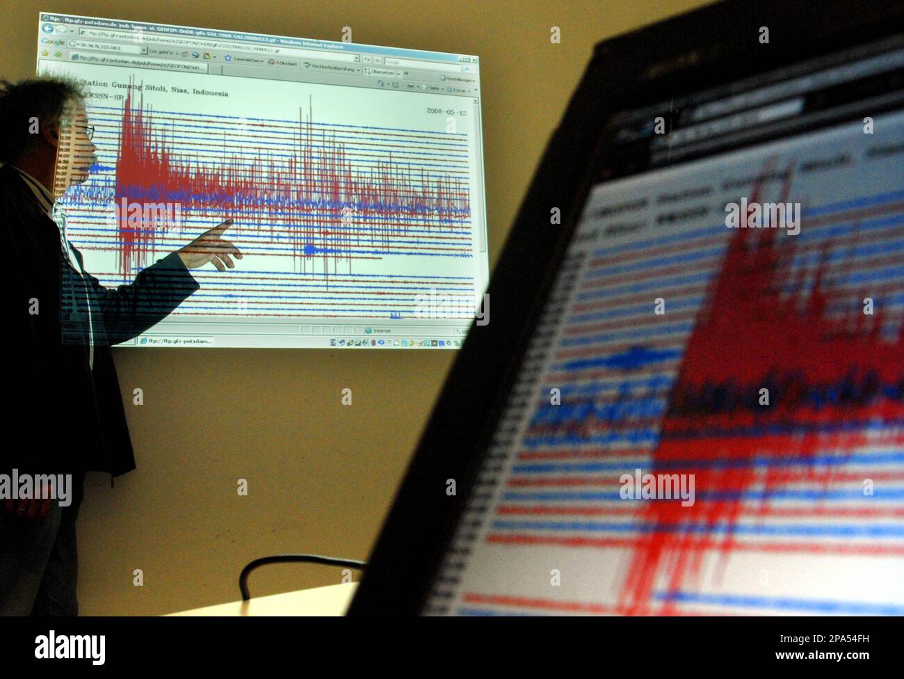 Seismologist Guenter Asch explains the graphic display of the recent ...