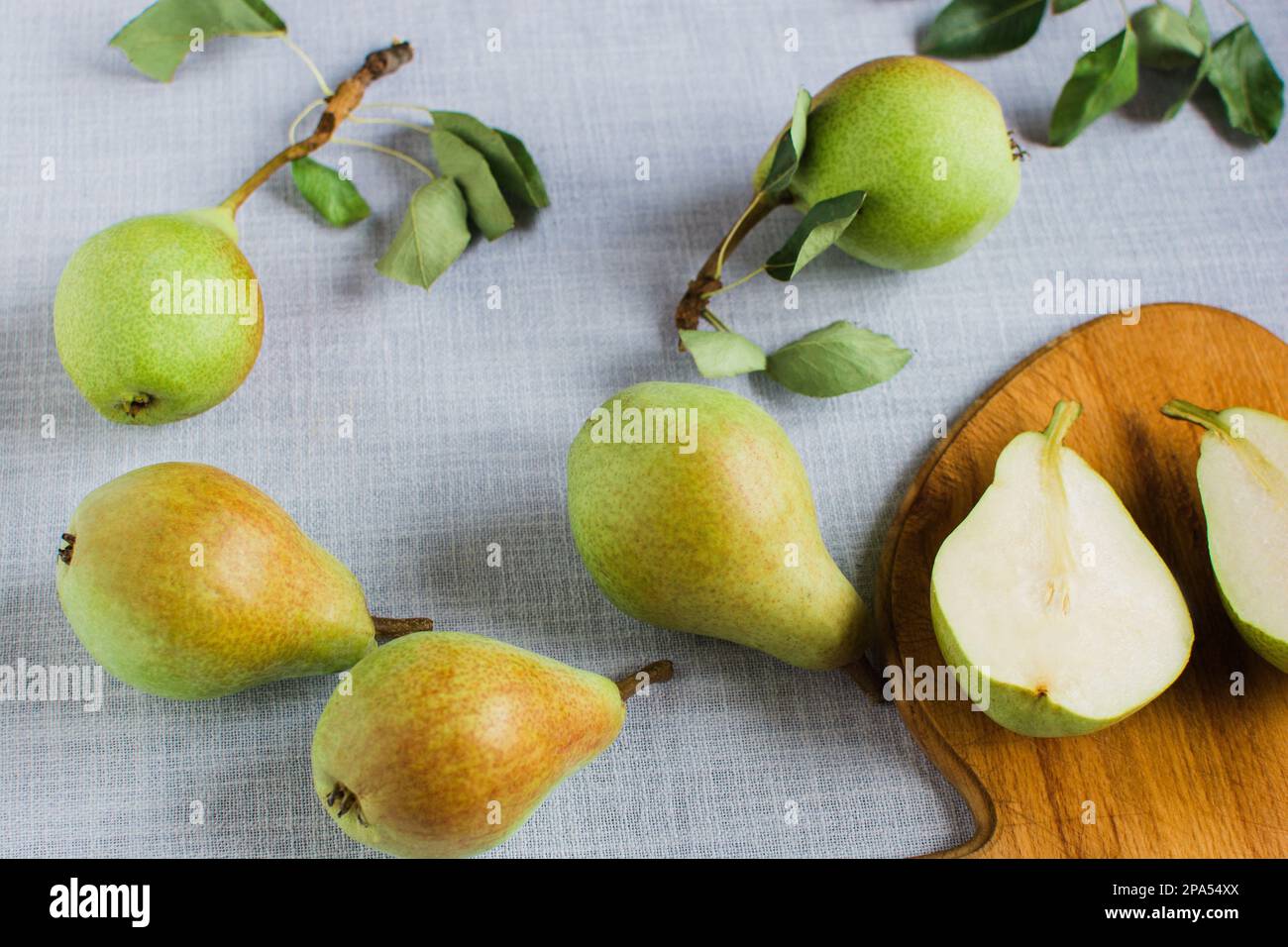 pears in a plate and slices of pears top view. wooden background with ...