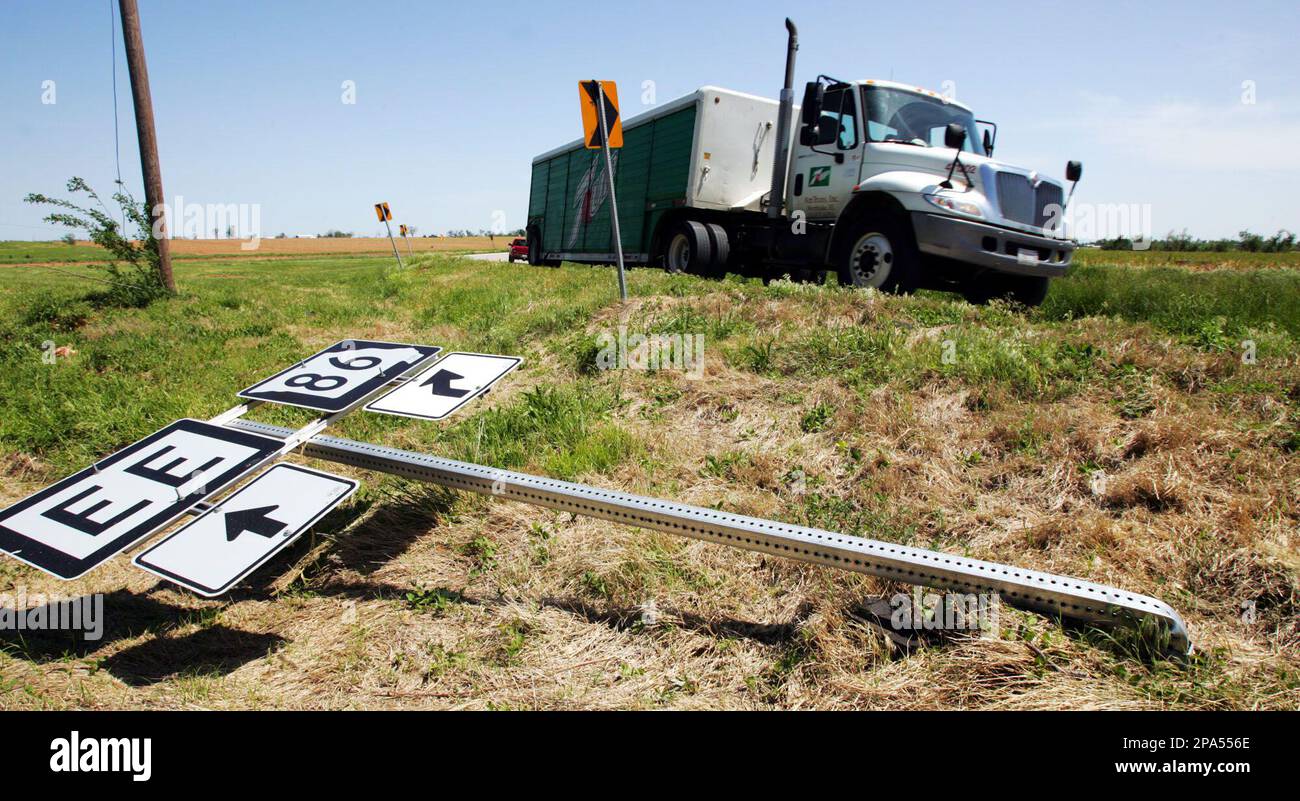 Motorists drive past blown-down road signs on Missouri 86 on the ...