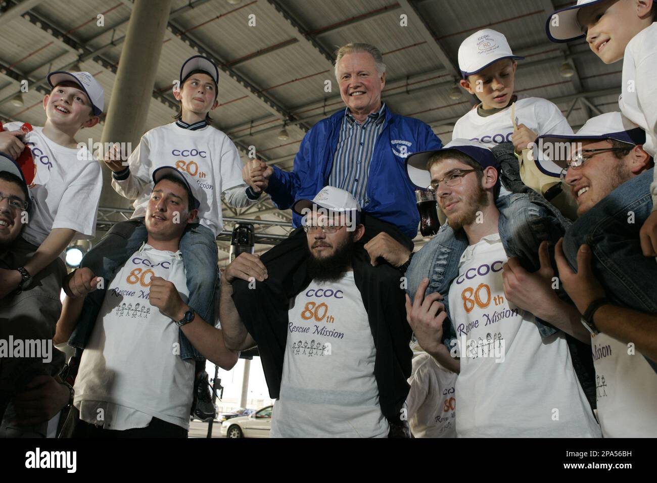 Academy Award winning actor Jon Voight, center, is carried as he and ...