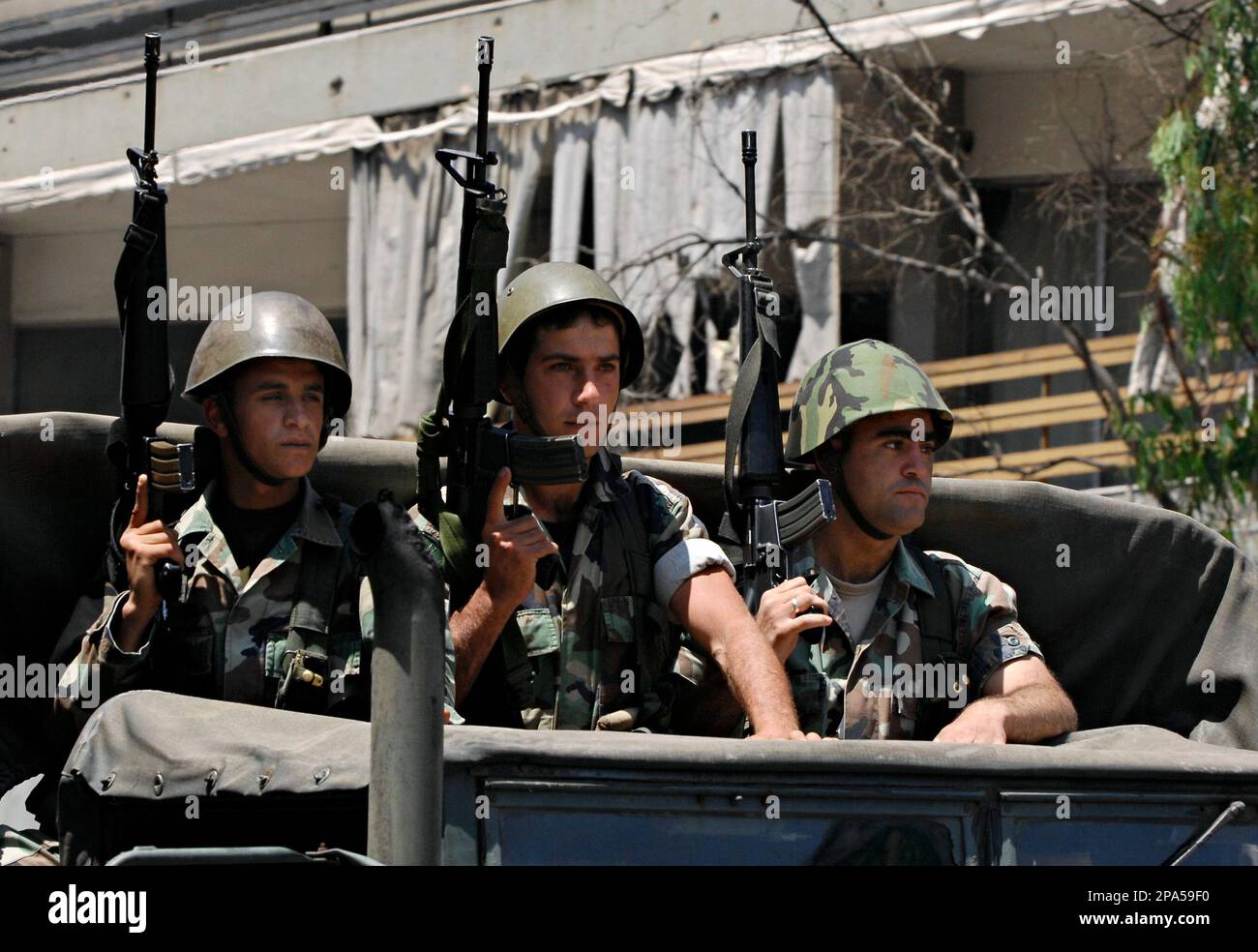 Lebanese soldiers are seen on their truck while patrolling Beirut ...