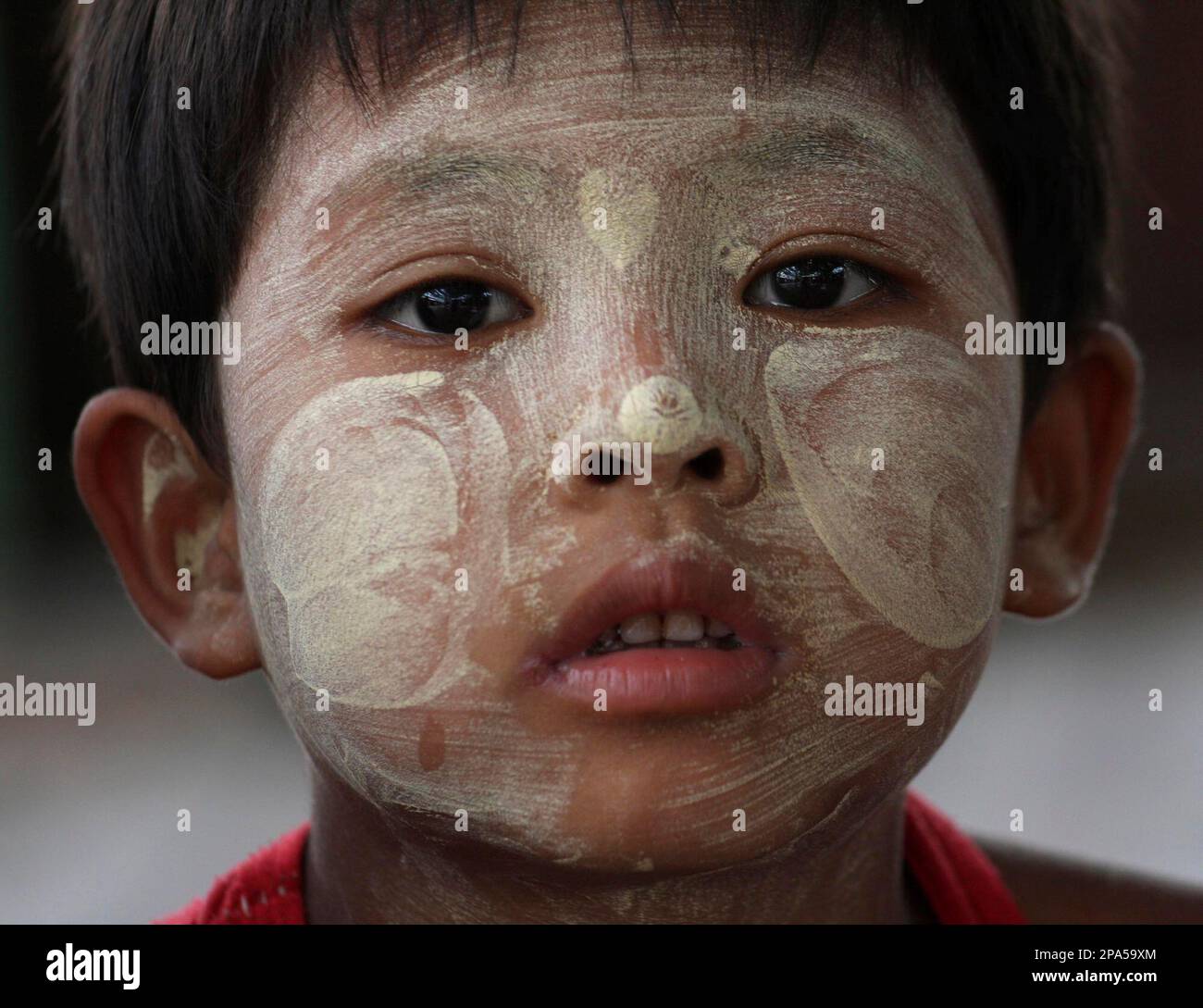 A homeless villager, with traditional makeup on, gathers at the ...