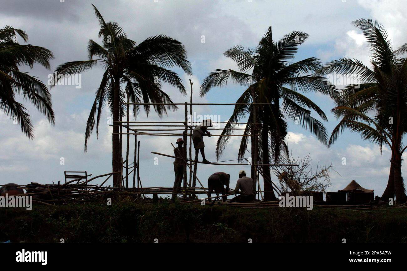 Villagers work on a house in Pyapon, a town in the Irrawaddy delta of ...