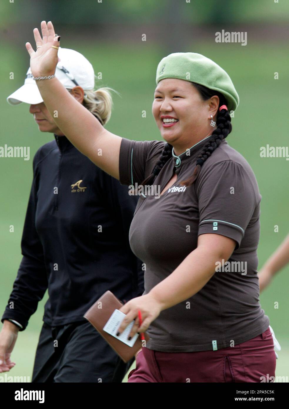 Christina Kim waves to the crowd after finishing her round at the ...