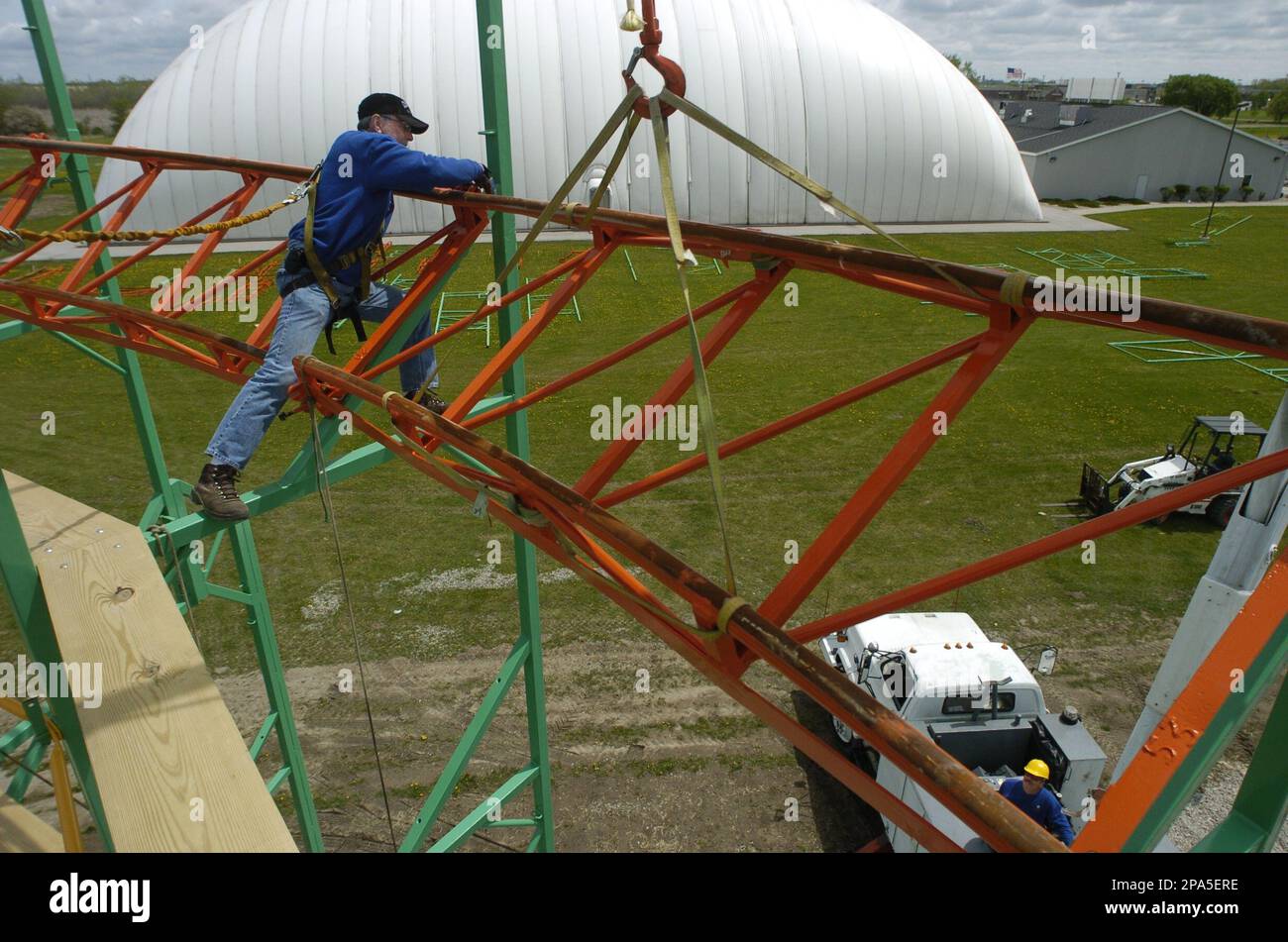 Maintenance Manager Gary Gilbert bolts a 400-pound section of track ...