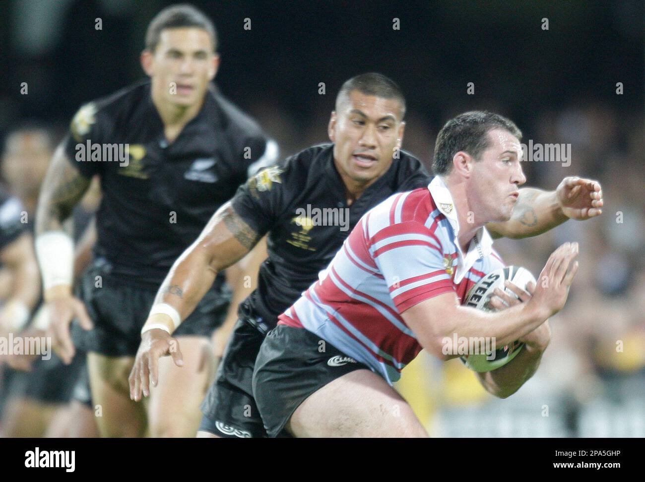 New Zealand's David Fa'alogo, center, reaches out to stop Australia's ...