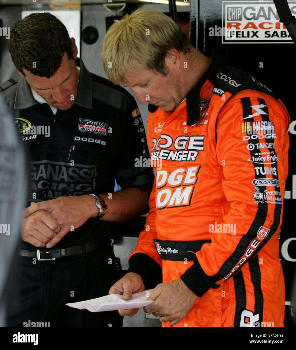 NASCAR driver Sterling Marlin, right, looks at a print out with his ...