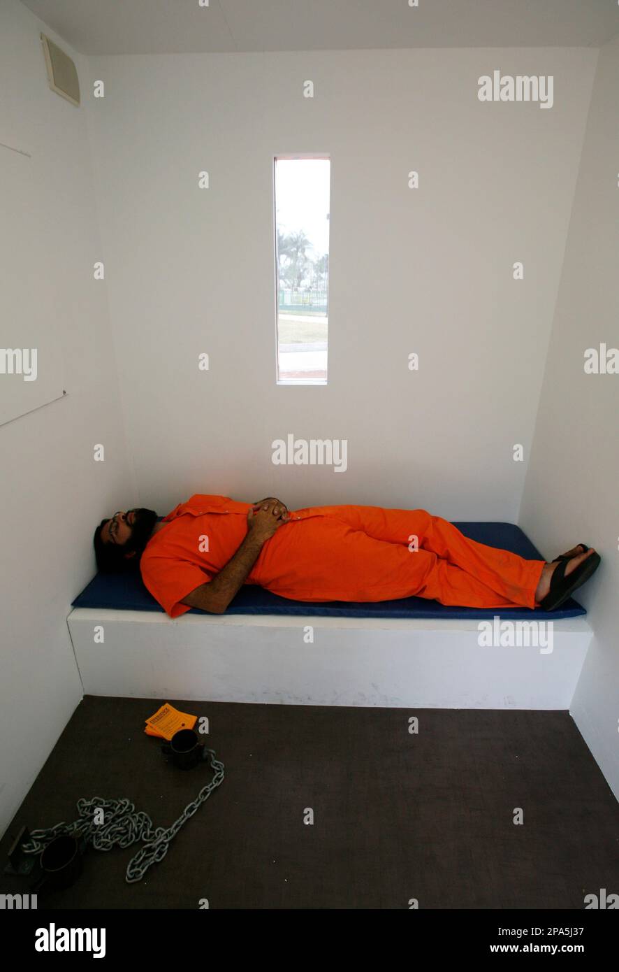 Activist Muhammed Malik lies inside of a life-size Guantanamo prison ...