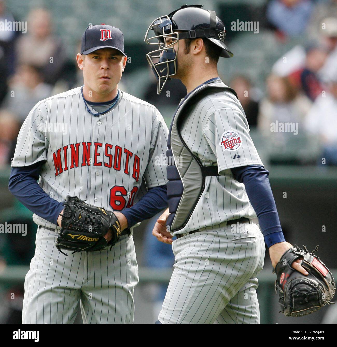 Minnesota Twins catcher Joe Mauer, right, talks to pitcher Brian Bass ...