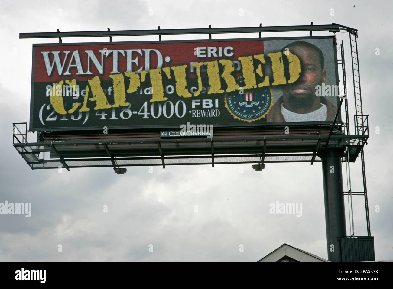 Shown is a digital billboard displaying the image of accused cop killer ...