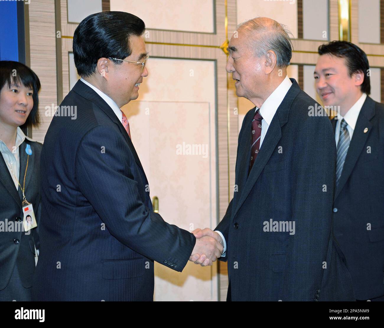 Chinese President Hu Jintao, center left, is welcomed by former ...