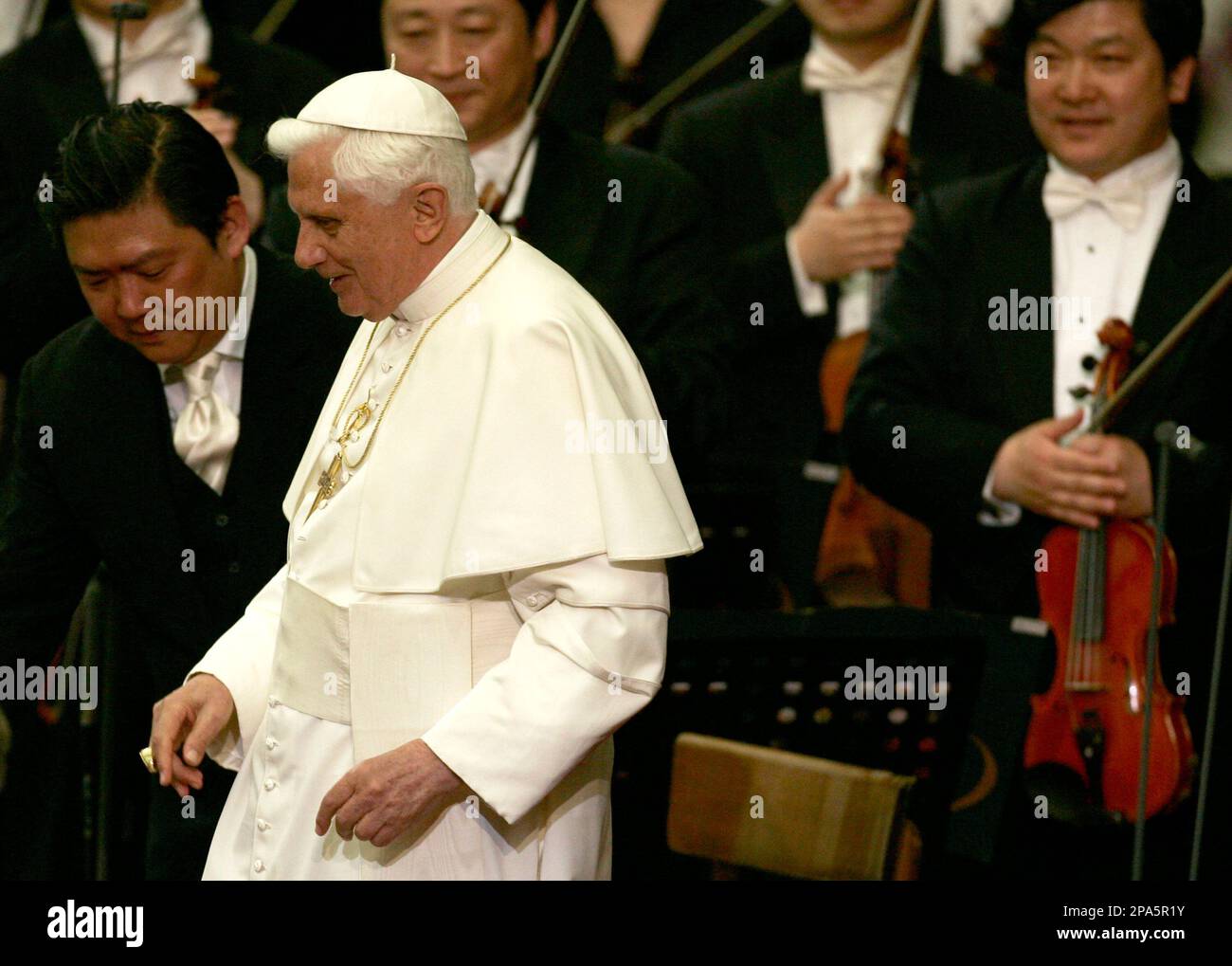 China Philarmonic Orchestra Conductor Long Yu, left midground, looks on ...