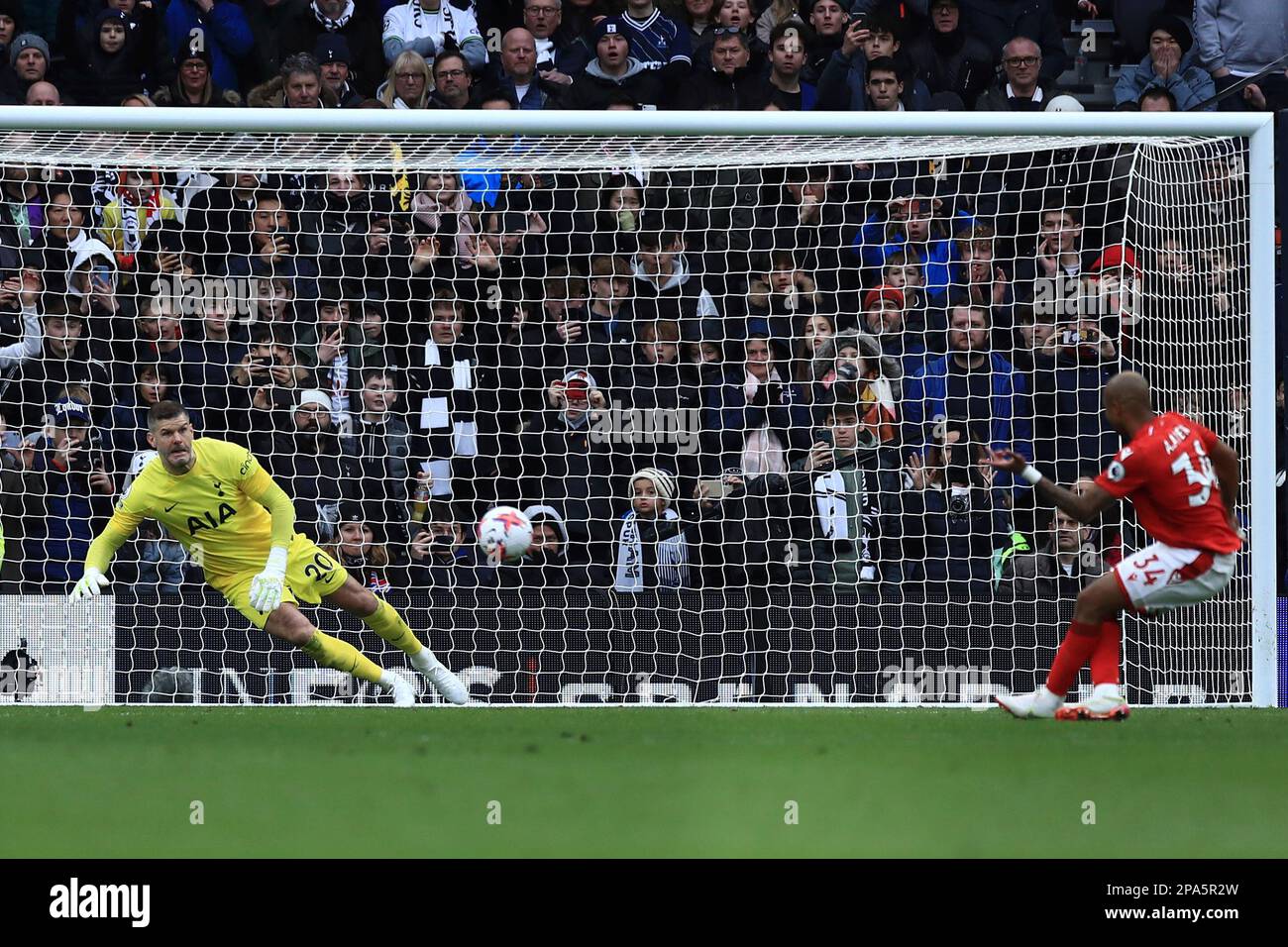 Tottenham's goalkeeper Fraser Forster, left, makes a save in front of ...