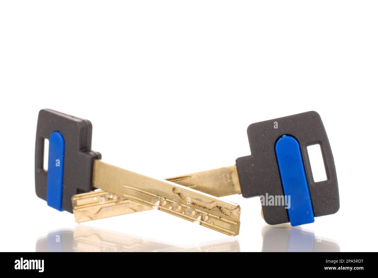 Two metal keys from a door lock, macro, isolated on white background ...