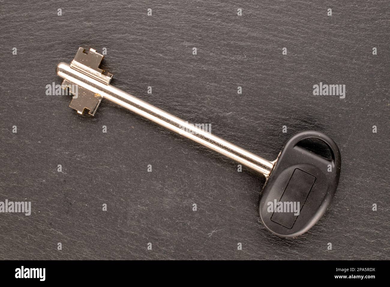 One metal door lock key on slate stone, macro, top view Stock Photo - Alamy